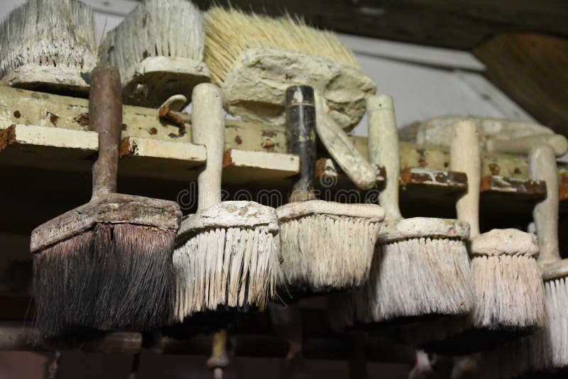 Some Paint Tassels Hung Up in Row Stock Photo - Image of grid, tools ...