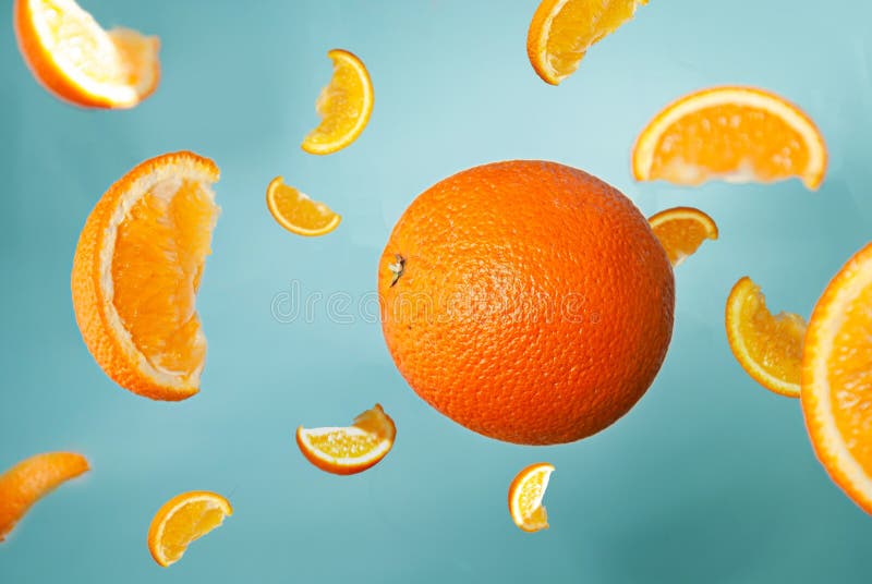 Some Pieces of Orange in a Different Size and One Big Entire Orange ...