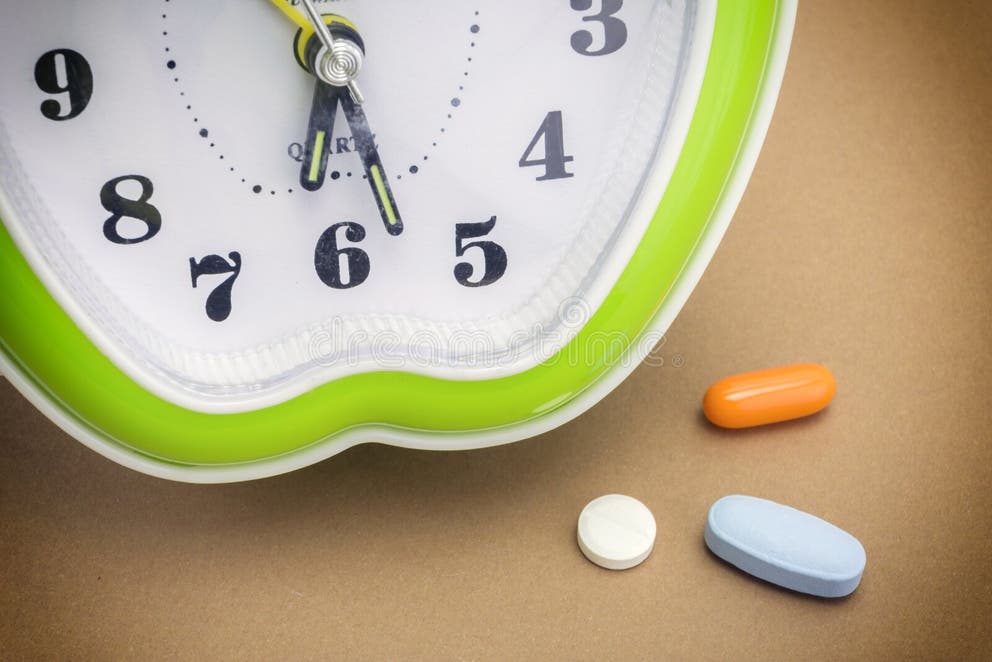 Some pills and green clock stock image. Image of health - 66705545