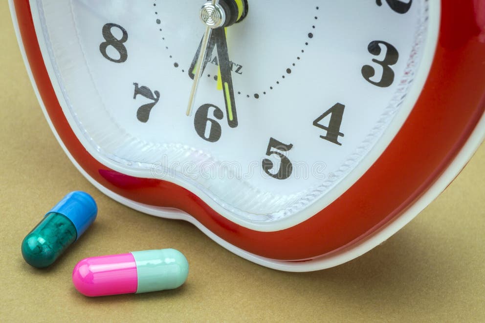 Some pills and red clock stock photo. Image of treatment - 66705748