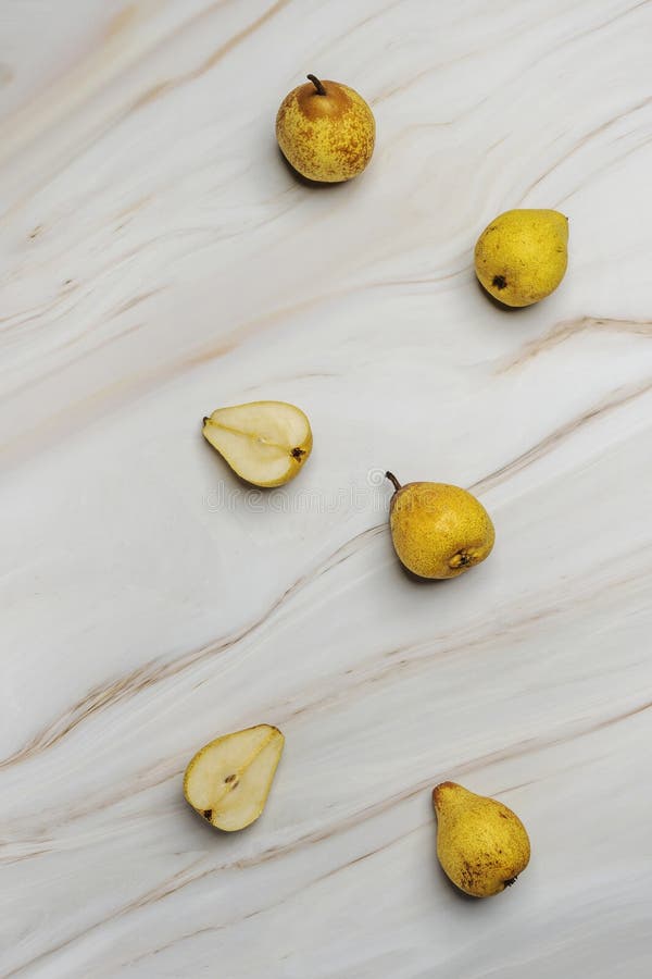 Some Ripe Pears on a White Marble Surface with Brown Veins Stock Image ...
