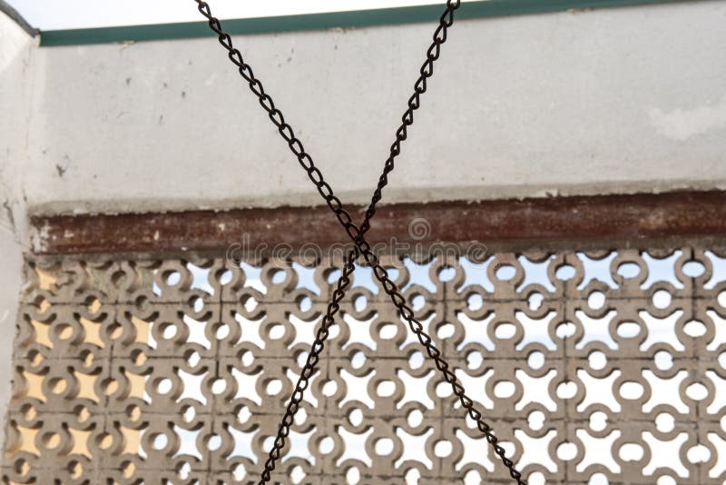 Some Rusty Chains Forming a Cross with a Cement Lattice with White ...