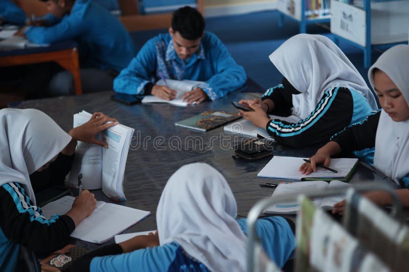 Some Students are Studying at a Table in the Library Editorial ...