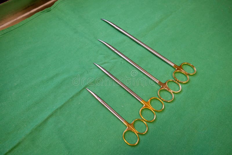 Some Surgical Scissors of Different Sizes Lie Side by Side on a Green ...