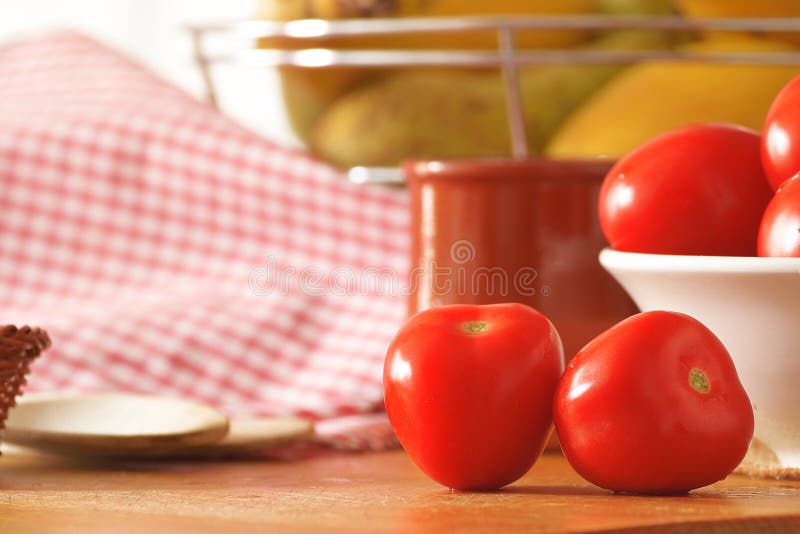 Some Tomatoes on a Wooden Table of a Rustic Kitchen while Cooking ...