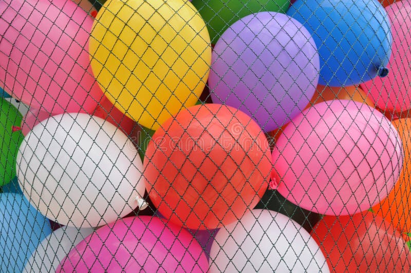 Toy balloons in a net stock image. Image of blue, yellow - 203668001