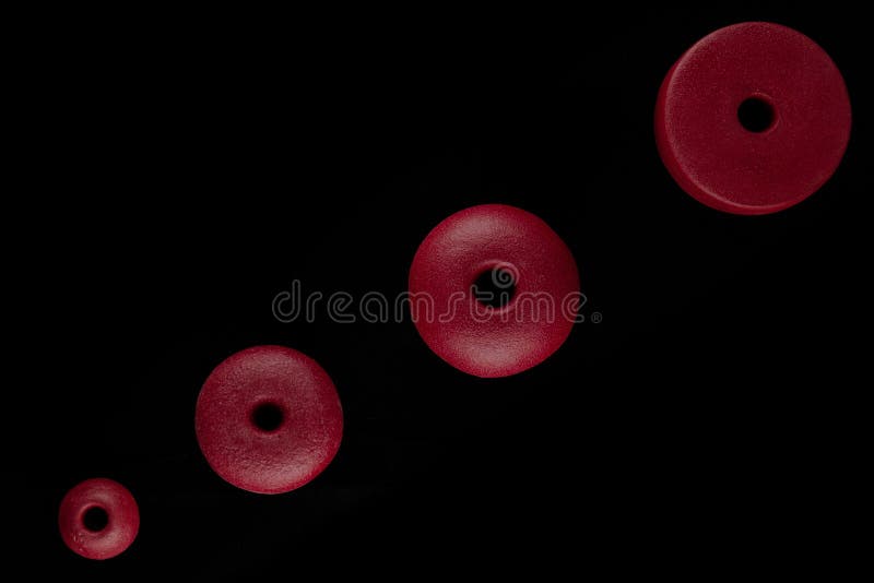 Some Very Big Red Donuts are on a Table at Night Stock Photo - Image of ...