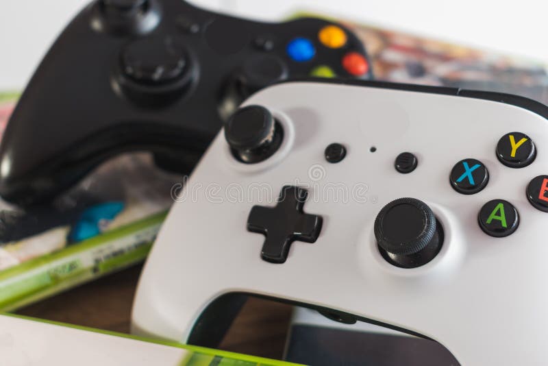 Some Video Game Controllers on Game Boxes Stock Photo - Image of black ...