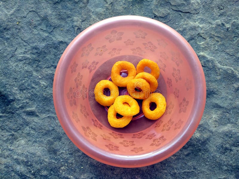 SOME YELLOW EATABLE FOOD PUT in a BOWL on STONE BACKGROUND Stock Image ...