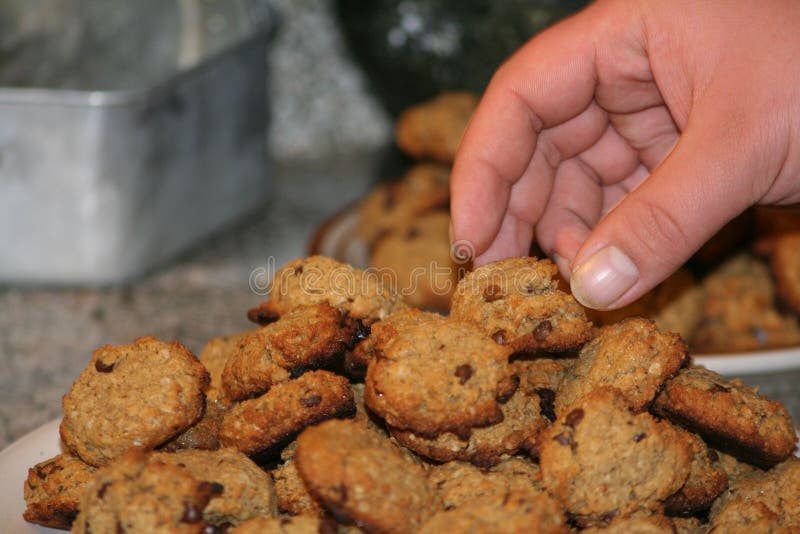 Someone Taking Chocolate Chip Cookies on Plate Stock Image - Image of ...