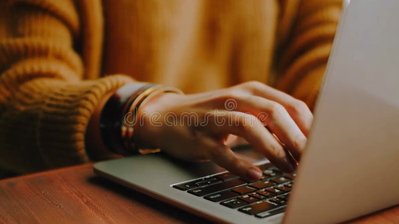 Someone is Typing on a Laptop with Focused Attention in a Warm ...