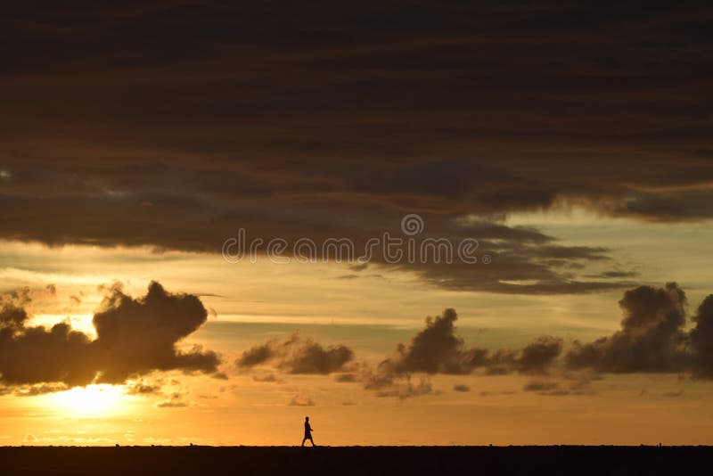 Someone Walking and Watching Sunset at the Beach Stock Image - Image of ...