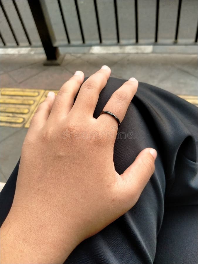 Someone Wears a Black Ring on the Index Finger Stock Image - Image of ...