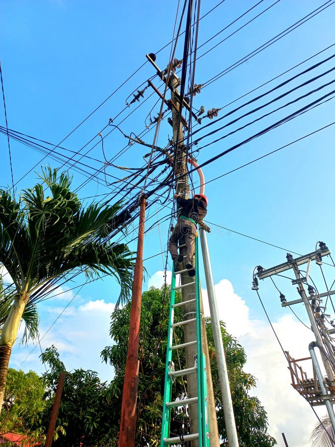 Someone is Working on Fixing Tangled Power Lines in a Power Tower. Stock Photo - Image of ...