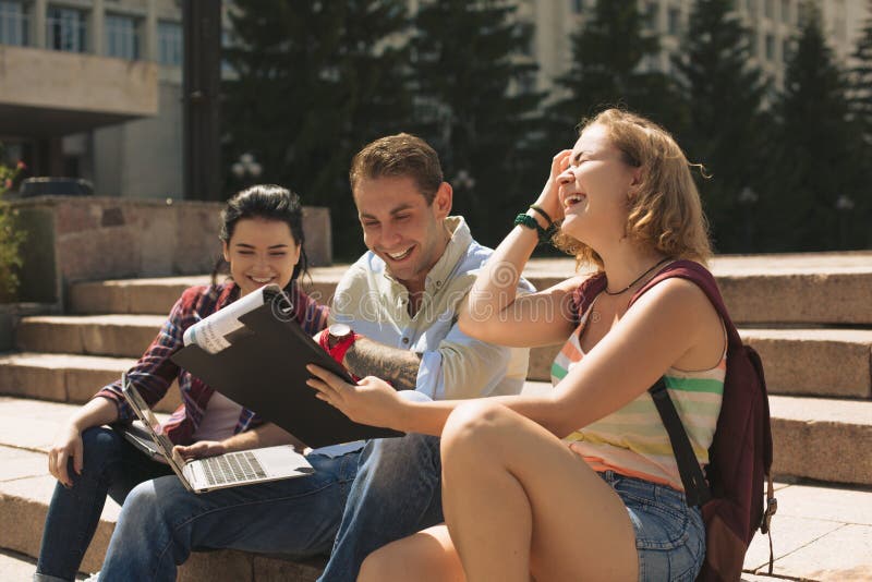 Group of Three Students Sitting on Stairs Stock Photo - Image of ...
