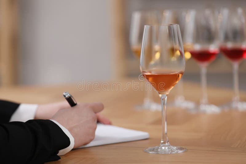 Sommelier Making Notes during Wine Tasting at Table Indoors, Closeup ...