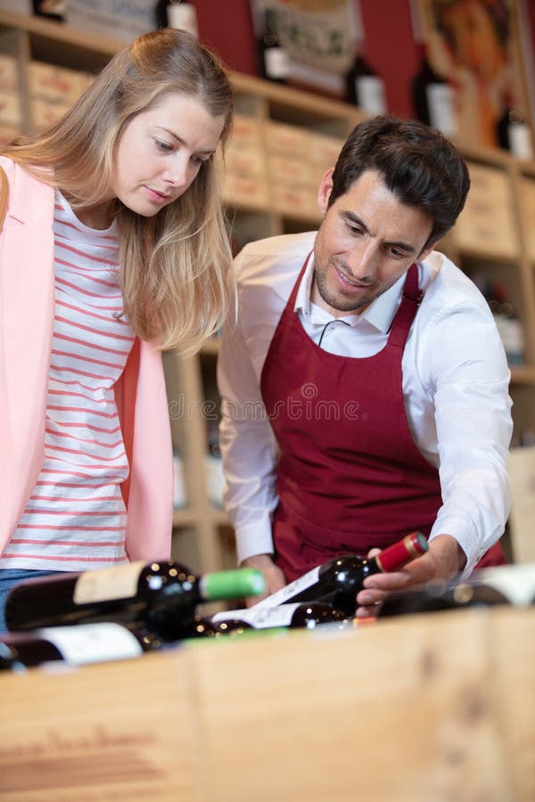 Sommelier in Wine Store Giving Woman Recommendation Stock Photo - Image ...