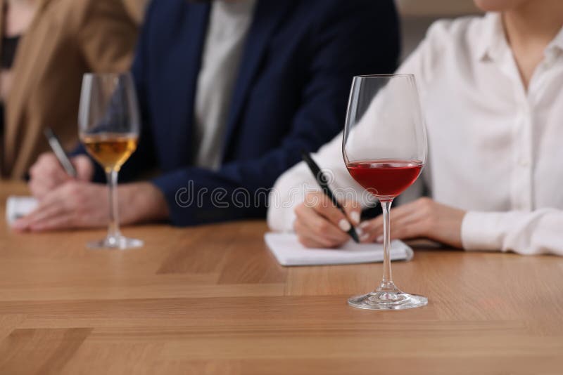 Sommeliers Making Notes during Wine Tasting at Table Indoors, Closeup ...
