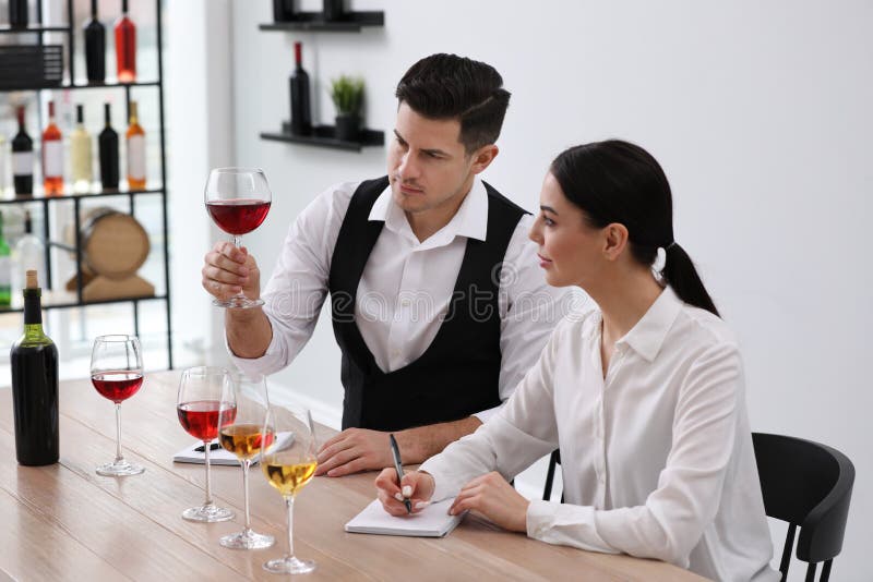 Sommeliers Tasting Different Sorts of Wine at Table Stock Photo - Image ...
