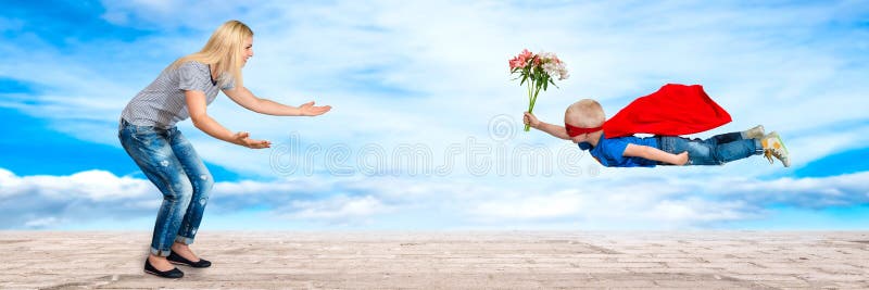 The Son In The Costume Of A Superhero Gives His Mother A Bouquet Of