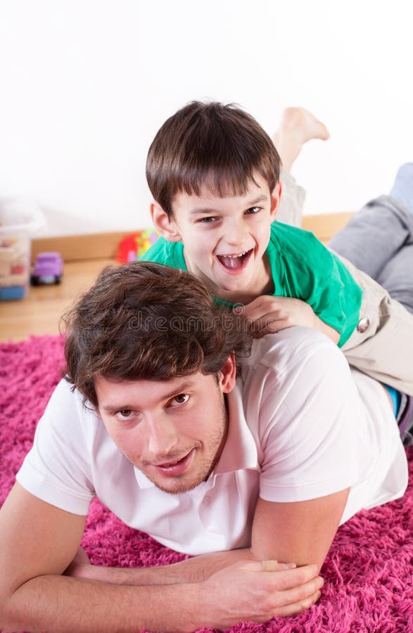 Father and Son Roughhousing at Home Stock Photo - Image of luck, single ...