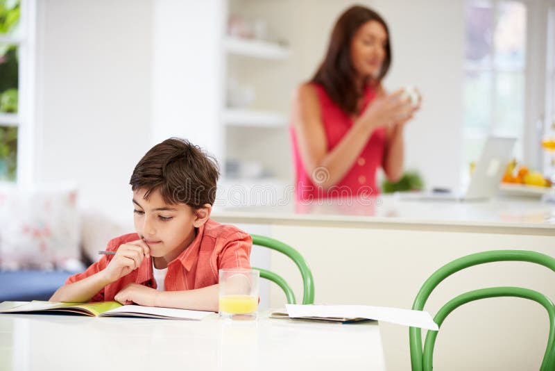 Son Does Homework As Mother Uses Laptop Stock Image - Image of smiling, hispanic: 36612583