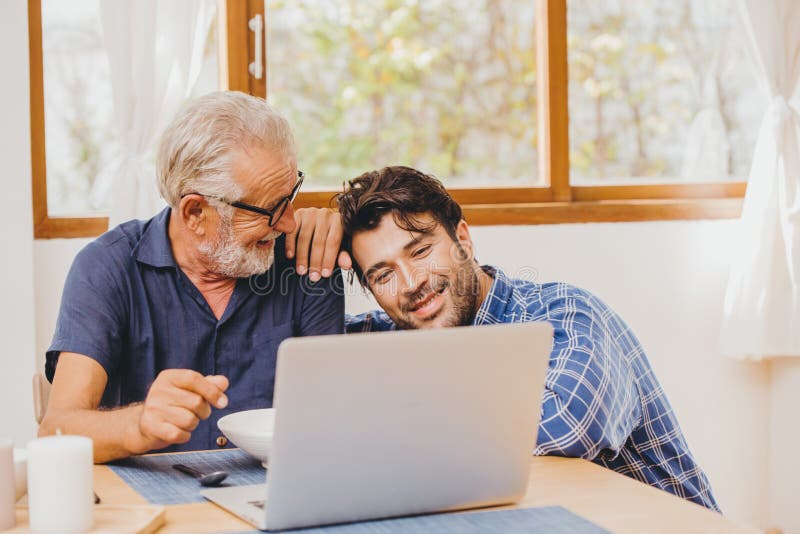 Son and Elder Father Happy Moment Together Looking at Laptop for Good ...