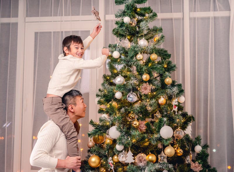 Son and Father Putting Star on Tree Stock Photo - Image of shiny ...