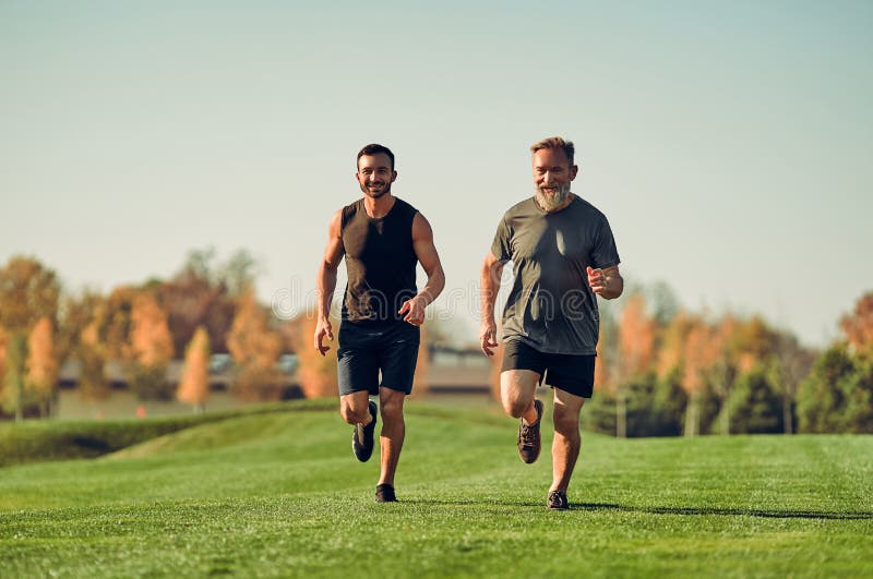The Son and Father Running on the Grass. Stock Photo - Image of ...