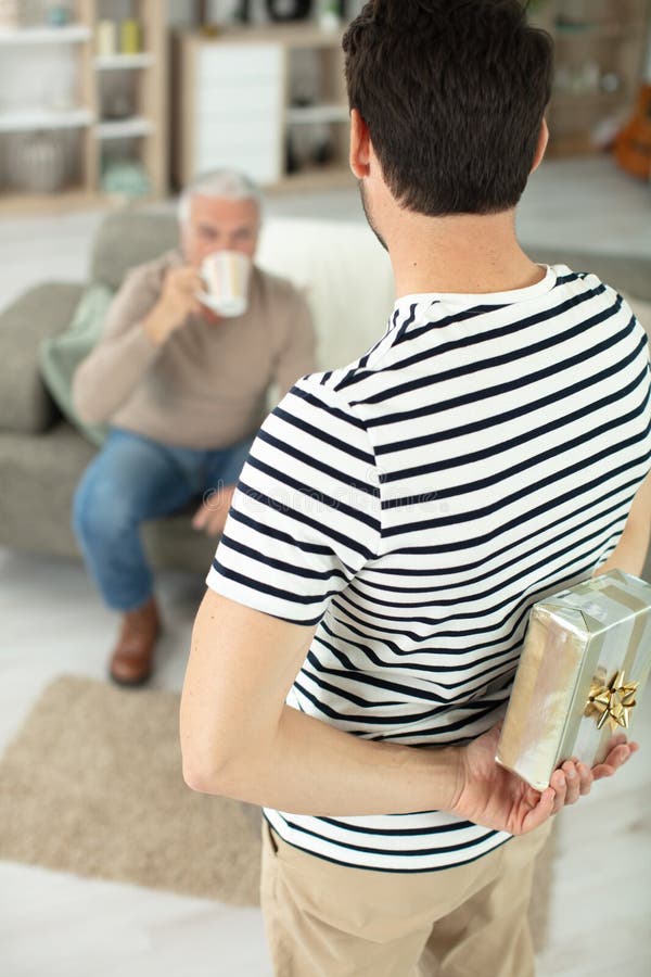 Son Giving To Father Pretty Gift Box at Home Stock Image - Image of ...