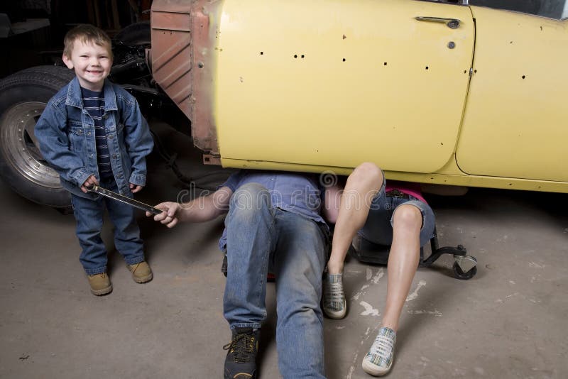 Son handing father a tool stock image. Image of family - 14076031