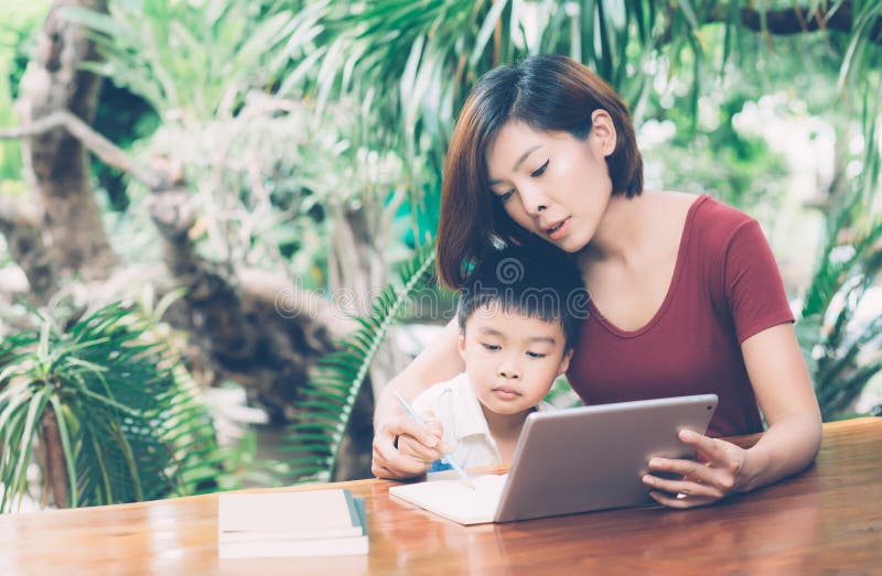 Son Using Digital Tablet Computer for Study and Learn To Internet ...