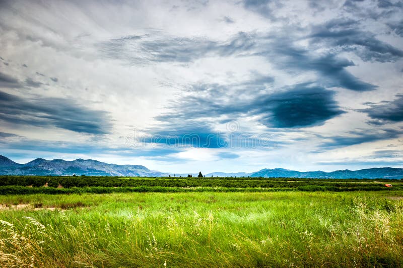 Soothing View of the Green Meadow and Cloudy Sky Stock Photo - Image of ...