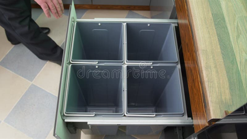 Sorting Garbage at Home. a Man in the Kitchen Opens a Trash Can Stock ...