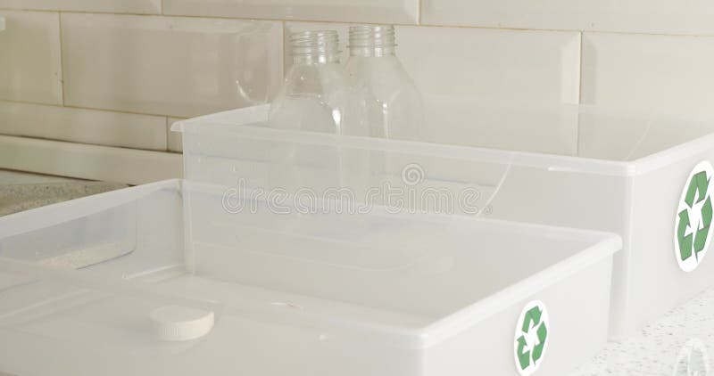 Sorting Plastic Waste into Boxes with a Recycling Sign. Close-up of ...