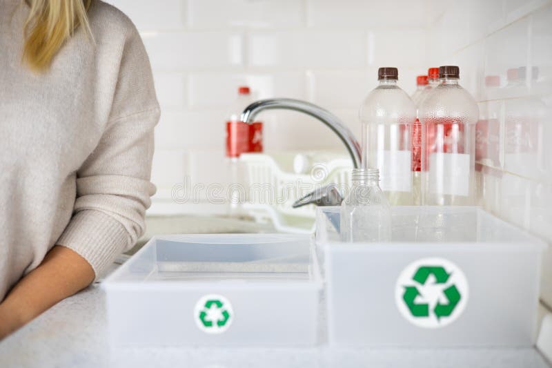 Sorting Plastic Waste into Boxes with a Recycling Sign. Close-up of ...
