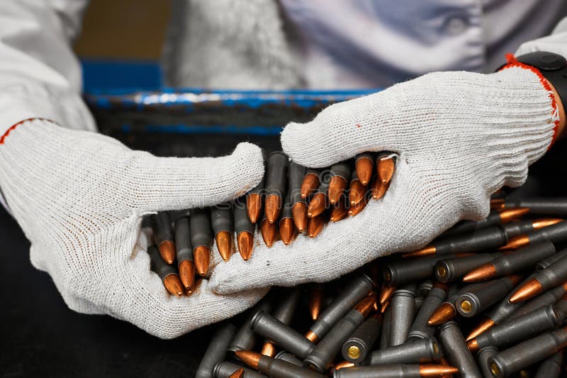 Sorting and Selective Quality Control of Weapon Cartridges. Hands of ...