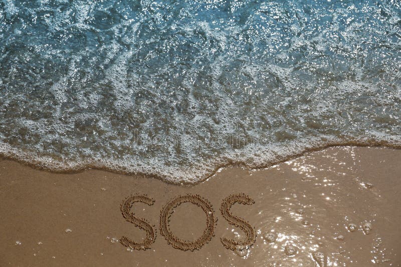SOS Message Drawn on Sandy Beach Near Sea, Above View Stock Photo ...