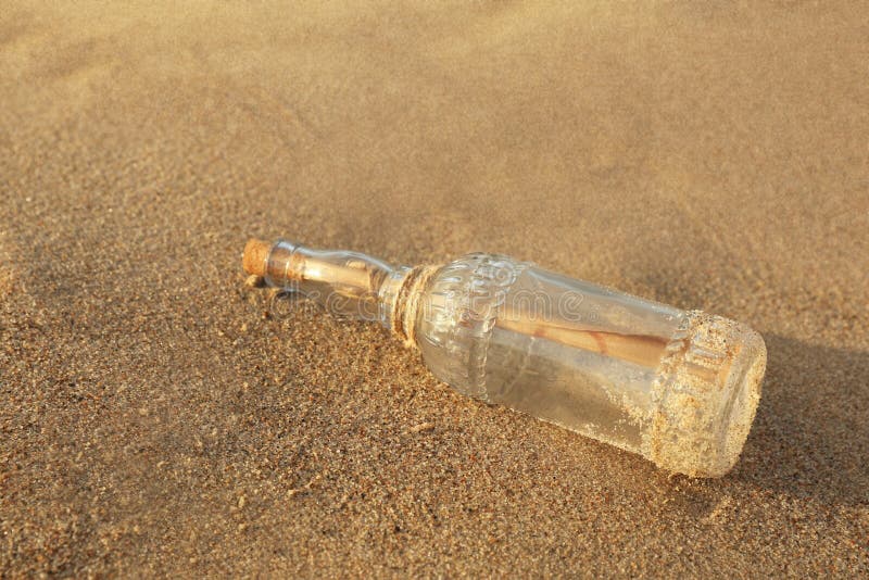 SOS Message in Glass Bottle on Sand, Closeup Stock Photo - Image of ...