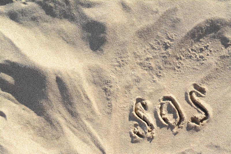 SOS Message Written on Sandy Beach Outdoors, Top View. Space for Text ...