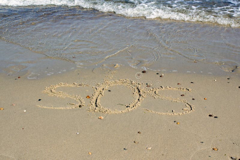 SOS - Word Drawn on the Sand Beach with the Soft Wave. Stock Image ...
