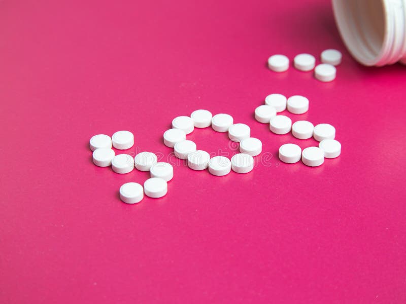 SOS Word Made of Pills and Capsules on a Pink Background. Pills on a ...