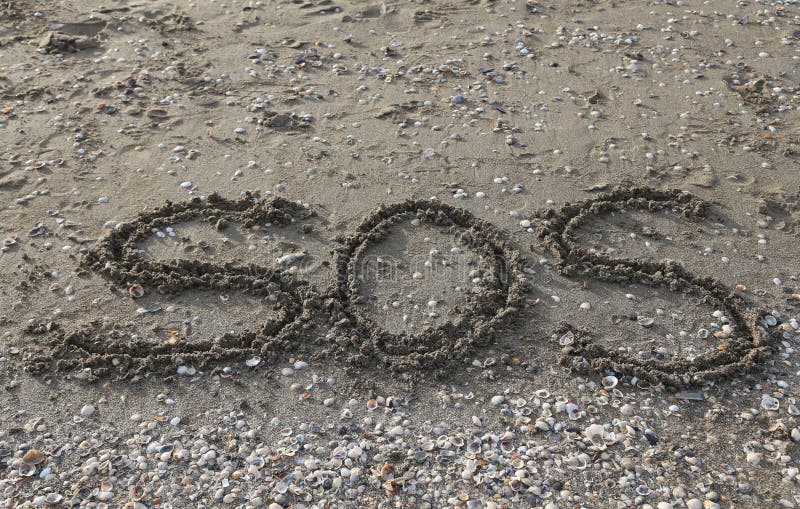 SOS written on the beach stock image. Image of symbol - 75343539
