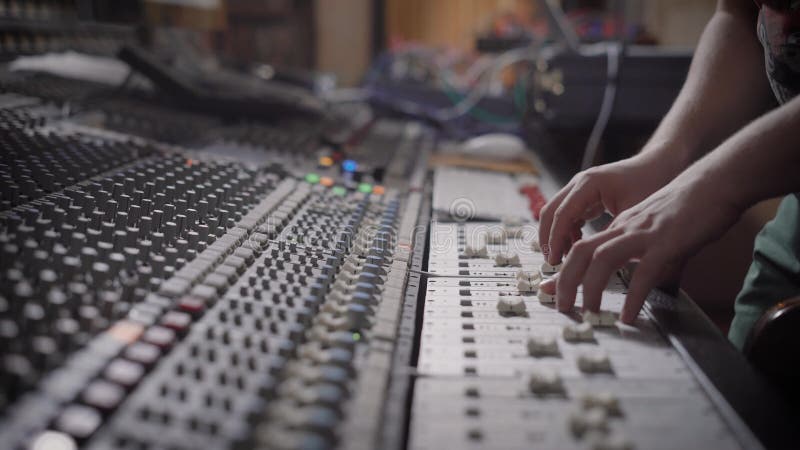 Sound Engineer is Moving Levers of a Multitrack Mixing Console in the ...