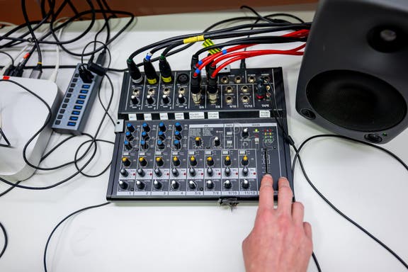 Sound Engineer Working on Audio Mixing Console with Cables Connected ...