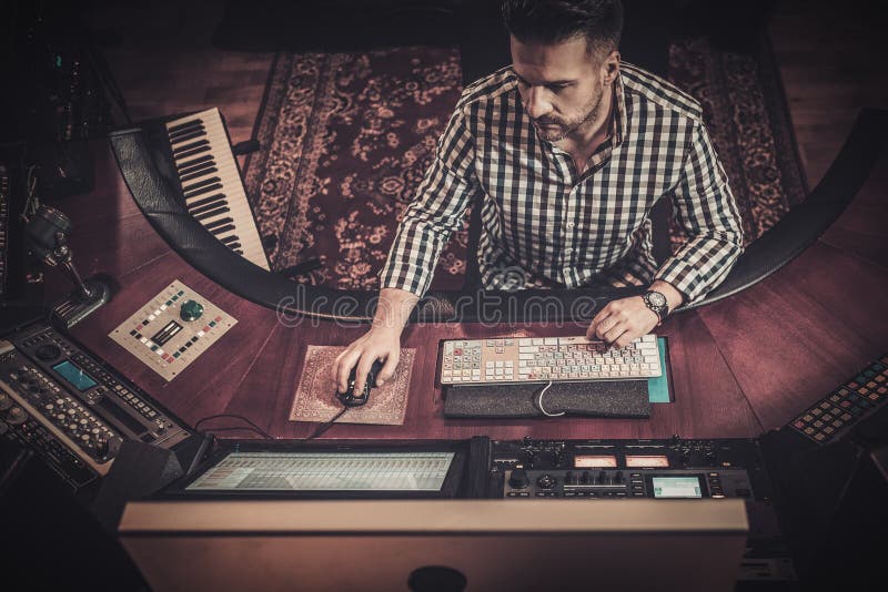 Sound Engineer and Producer Working Together at Mixing Panel in the ...