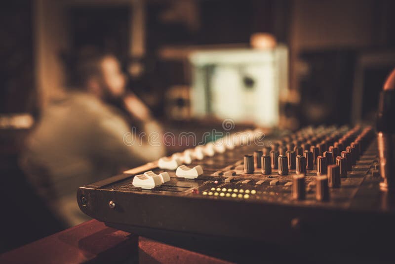 Sound Engineer Working at Mixing Panel in the Boutique Recording Studio ...