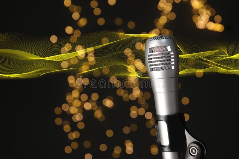 Sound Wave and Microphone Against Black Background with Blurred Lights ...