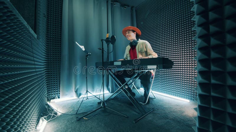 Soundproof Booth with a Male Performer Playing the Piano Stock Video ...