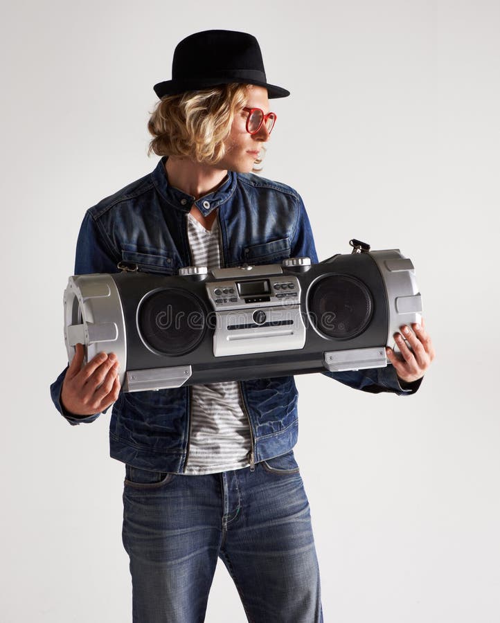 The Sounds of a Boombox. Studio Shot of a Handsome Young Man Holding a ...